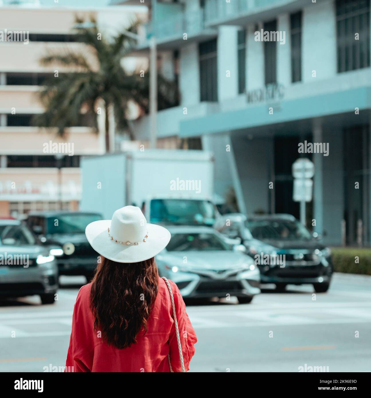 A lady in a red dress waiting on a street Stock Photo - Alamy