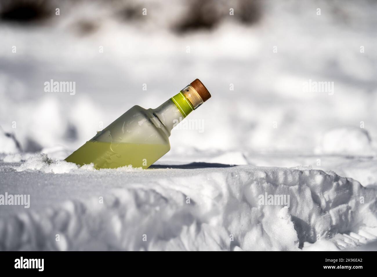 A close-up shot of an alcoholic bottle in a snow Stock Photo - Alamy