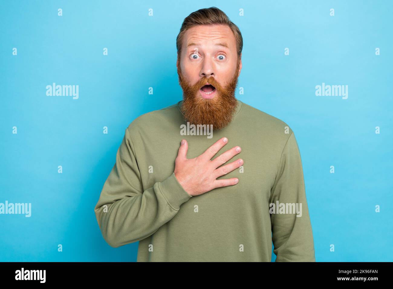 Photo portrait of attractive young man astonished touch chest frighten ...