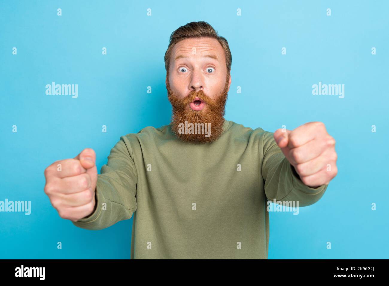 Portrait of careless speechless man with red hairstyle khaki pullover ...