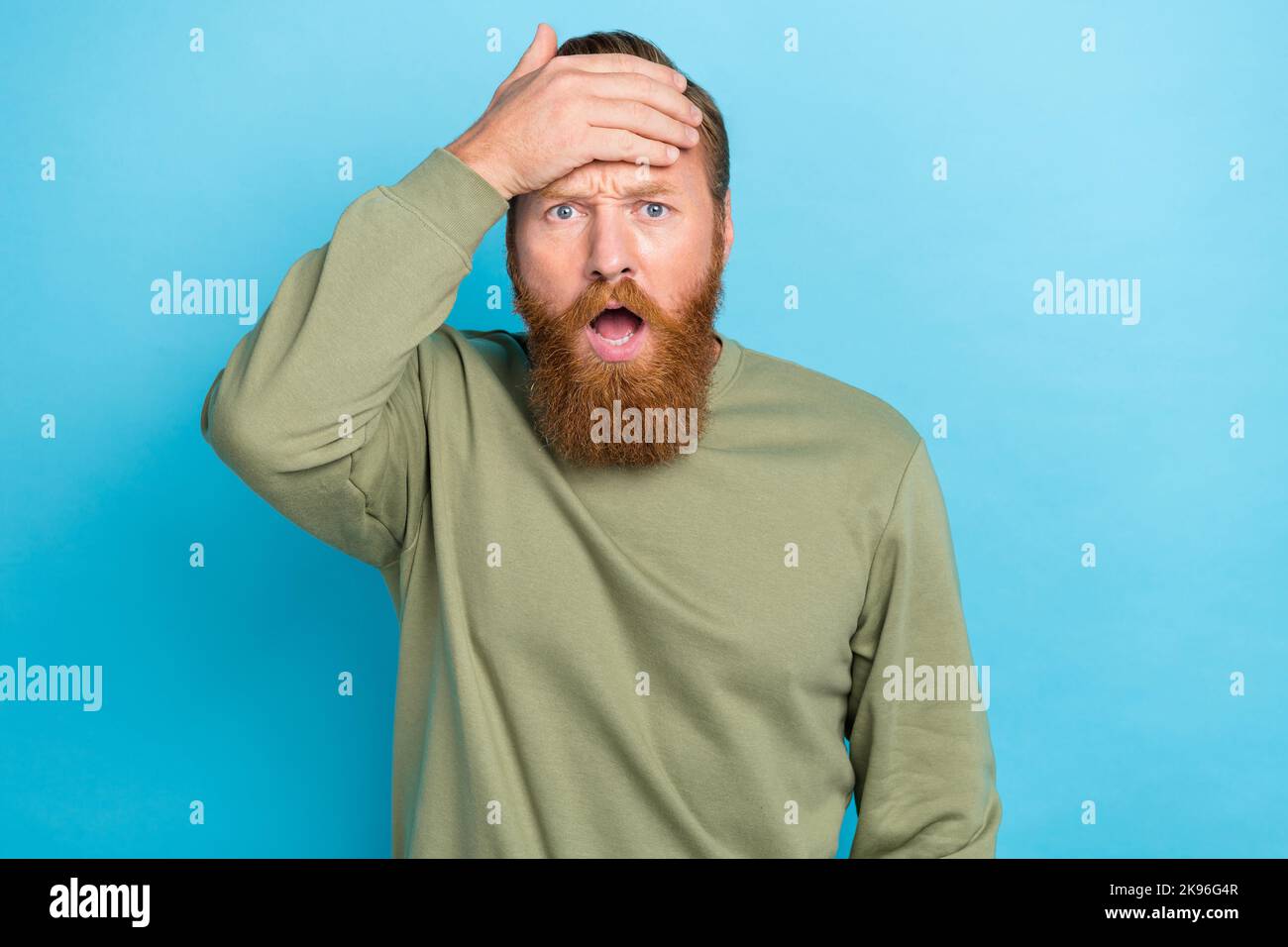 Photo of forgetful handsome guy with ginger hairstyle khaki long sleeve ...