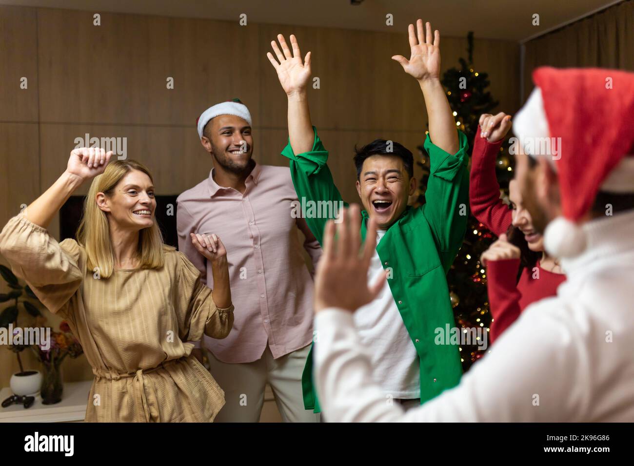 Group friends celebrate New Year's party at home dancing together ...