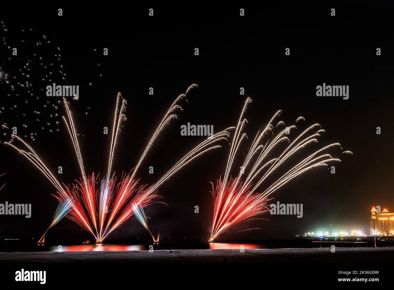 A scenic view of beautiful fireworks exploding in the skies of Doha ...