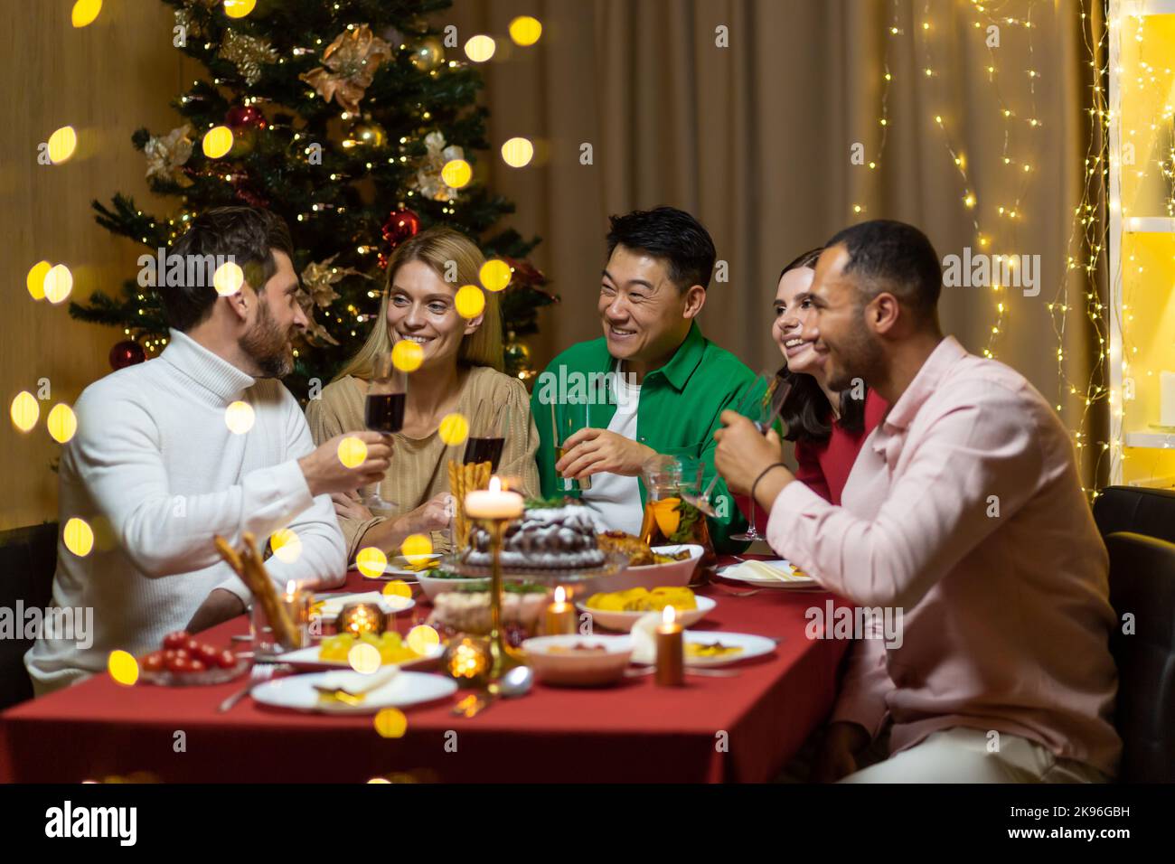 Friends celebrate Christmas eve or New Year holiday paty together ...