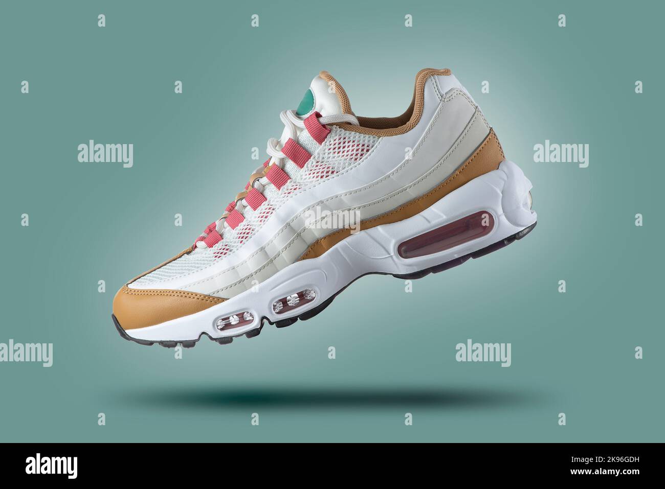 White sneaker with colored accents on a green gradient background ...