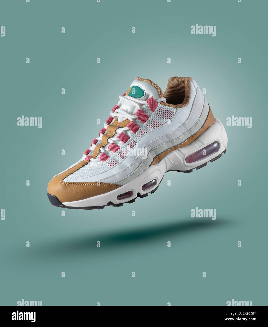 White sneaker with colored accents on a green gradient background ...