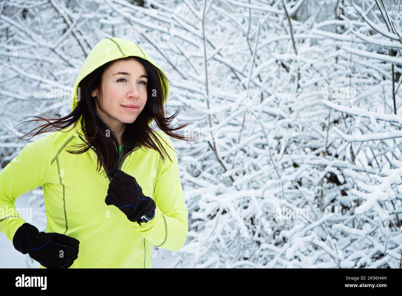 Cold Weather Running. Happy woman running in winter snowy park, forest ...