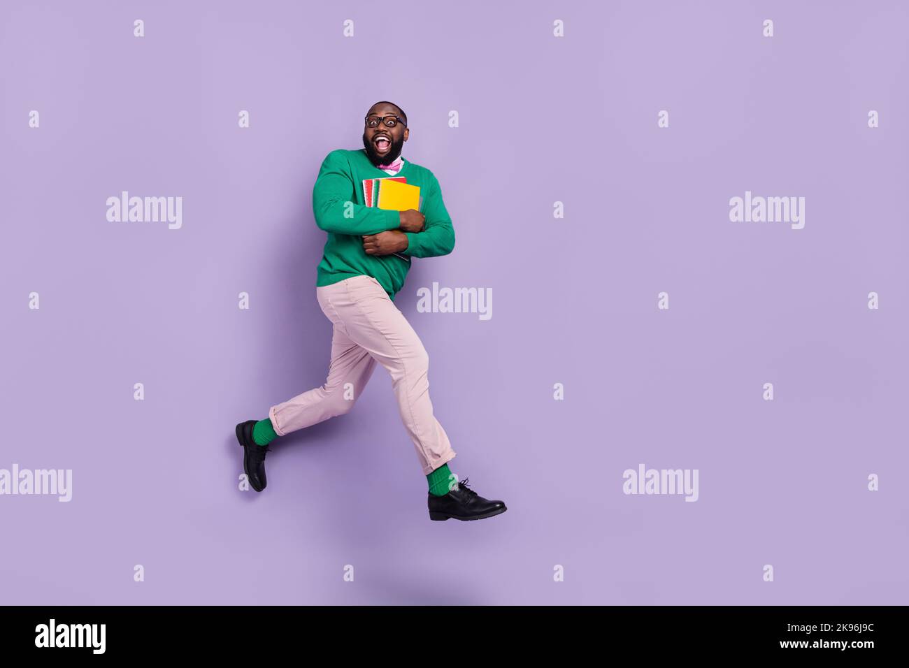 Full body image of excited young teacher running to his classroom hold ...