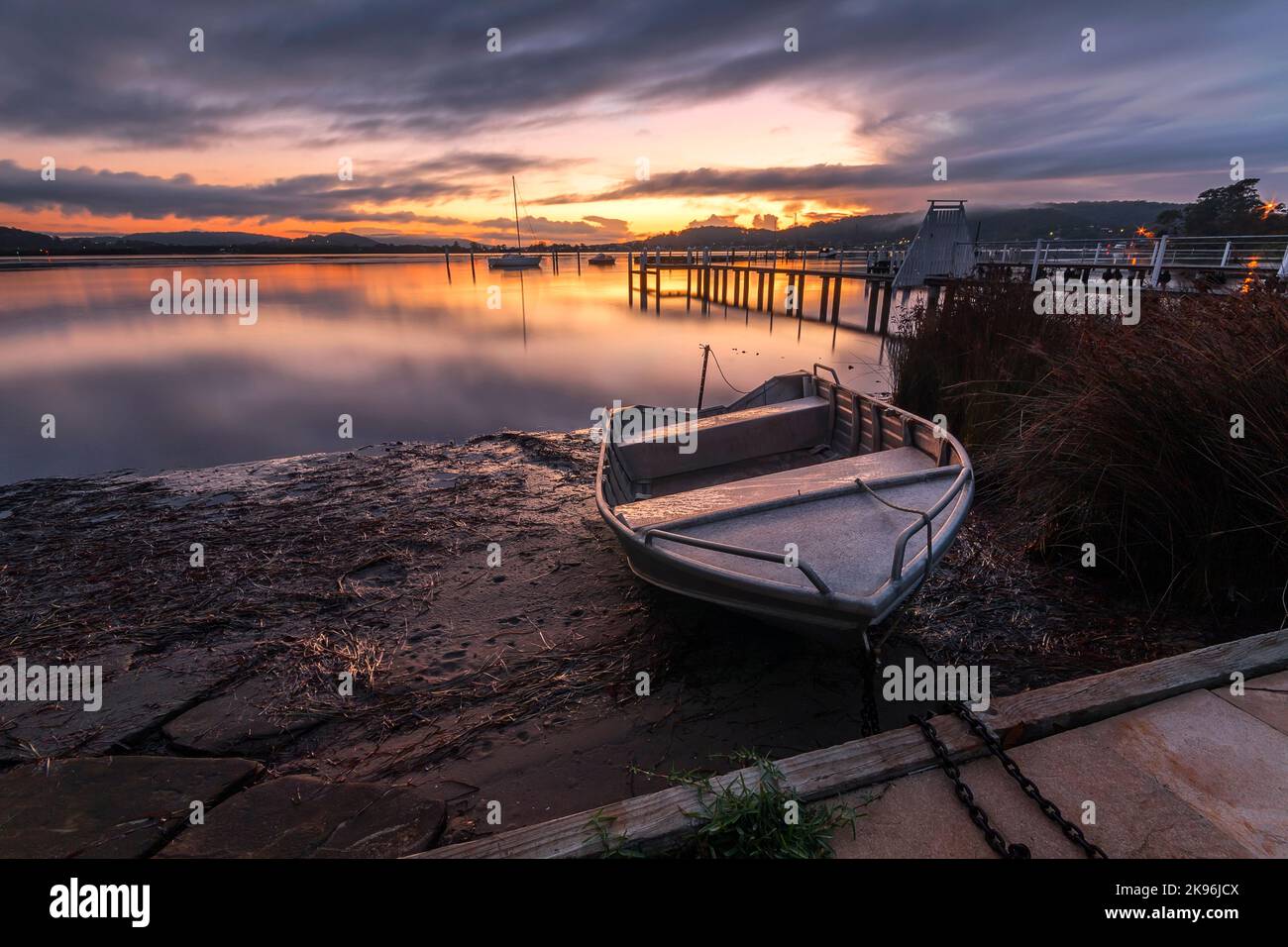 An empty boat on the shore at sunset. Brisbane Water, New South Wales ...