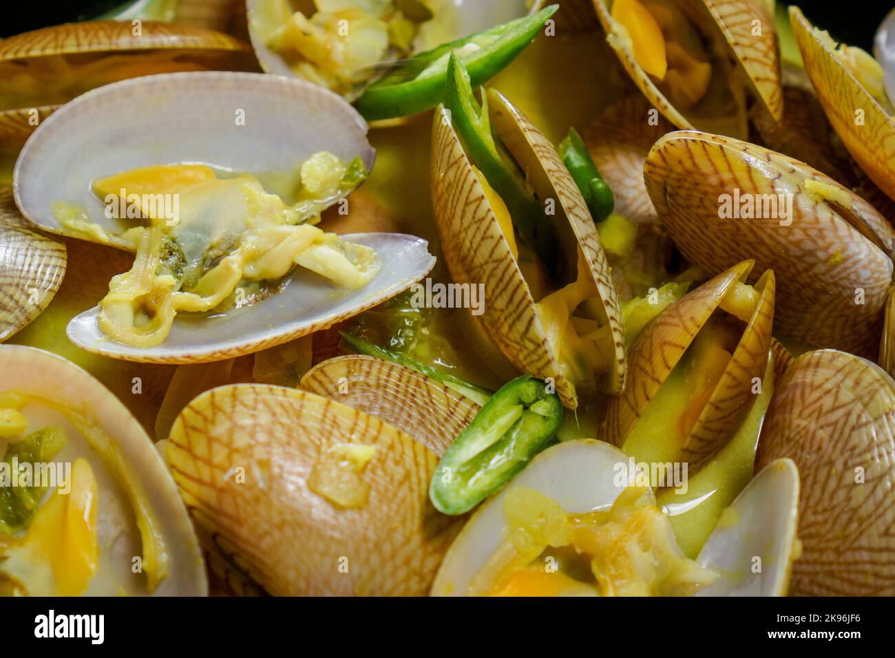 Lala or saltwater clams cooked in green curry and garnished with green ...