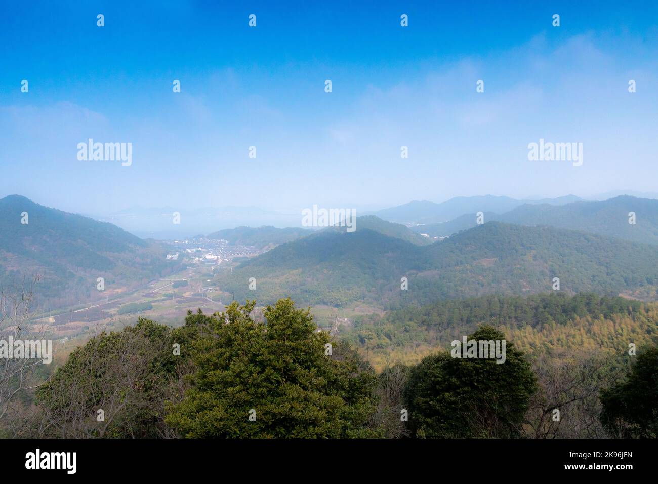 A view of mountains and greenery from a high peak in Ningbo, China ...