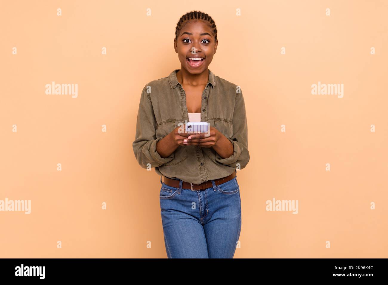 Portrait of attractive excited lady hold use telephone stare speechless ...