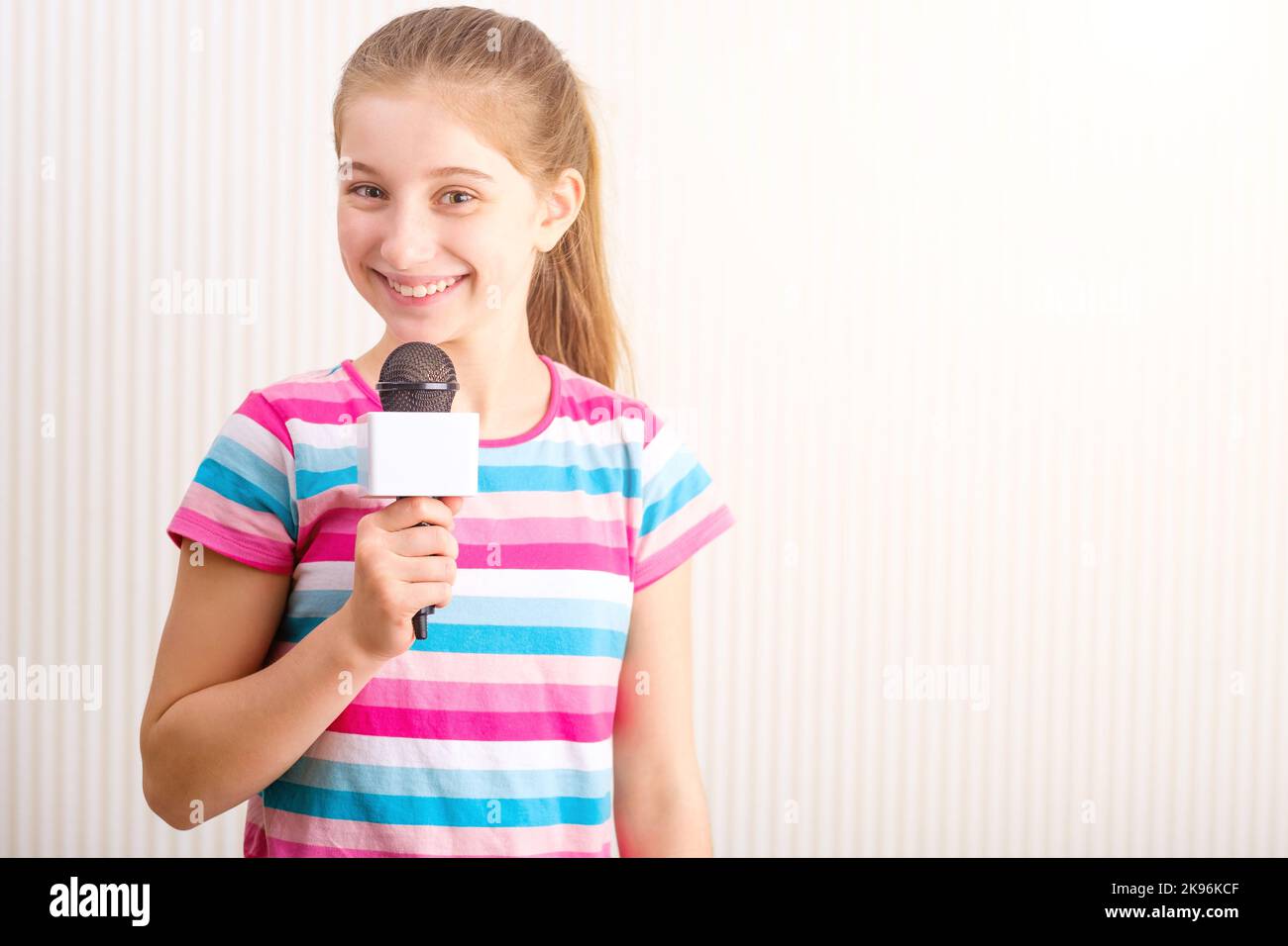 Girl talking in microphone Stock Photo - Alamy
