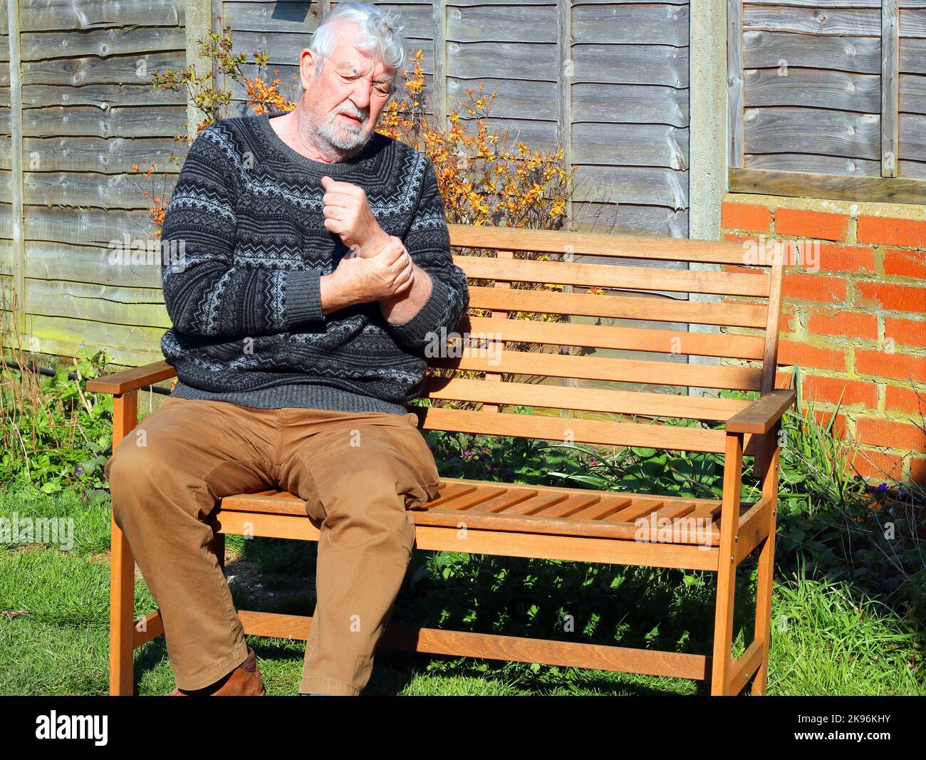 Senior or elderly man holding his wrist in pain. Agony caused by ...