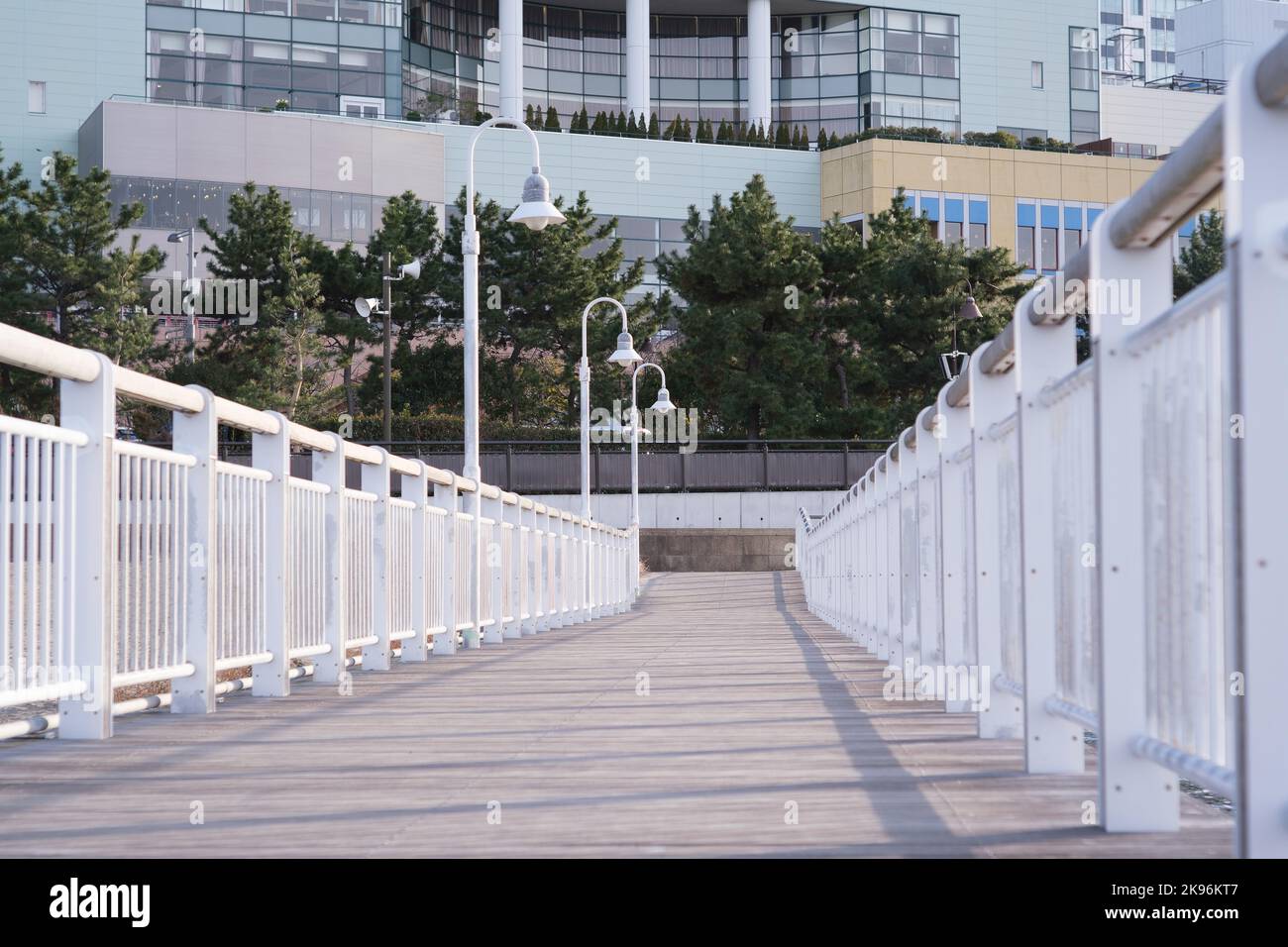 A low-angle shot of a walkway with white railings and lamp posts Stock ...