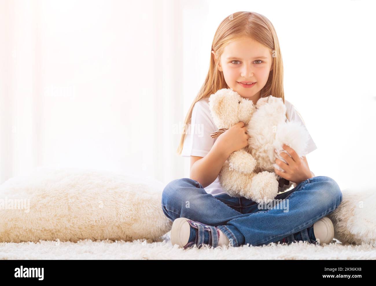 Girl hugging toys Stock Photo - Alamy