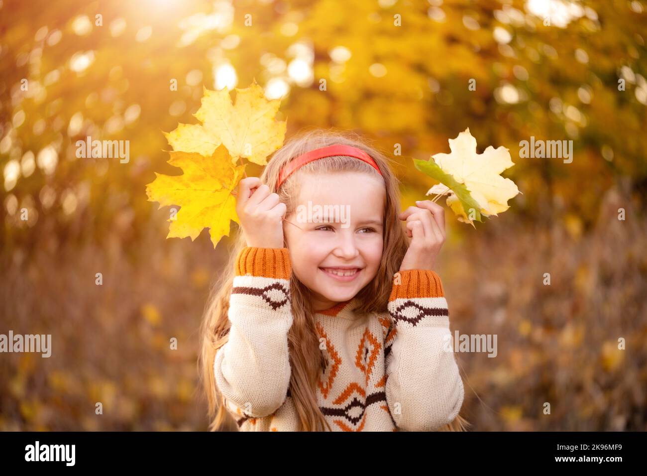 Child playing with autumn leaves Stock Photo - Alamy