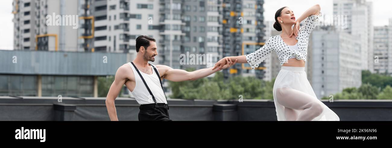 Dancers performing on rooftop of building outdoors, banner Stock Photo ...