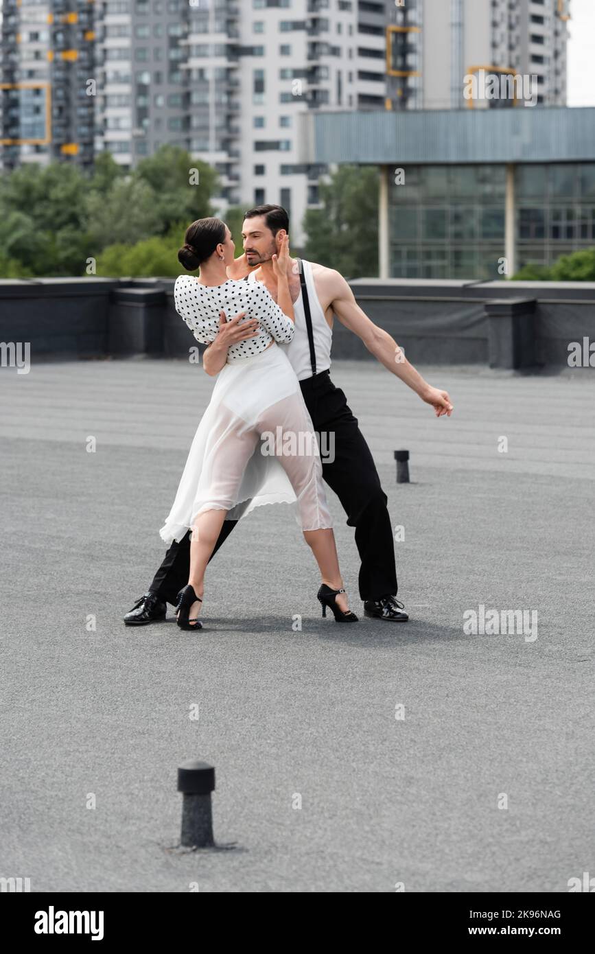 Professional ballroom dancers performing choreography on rooftop of ...