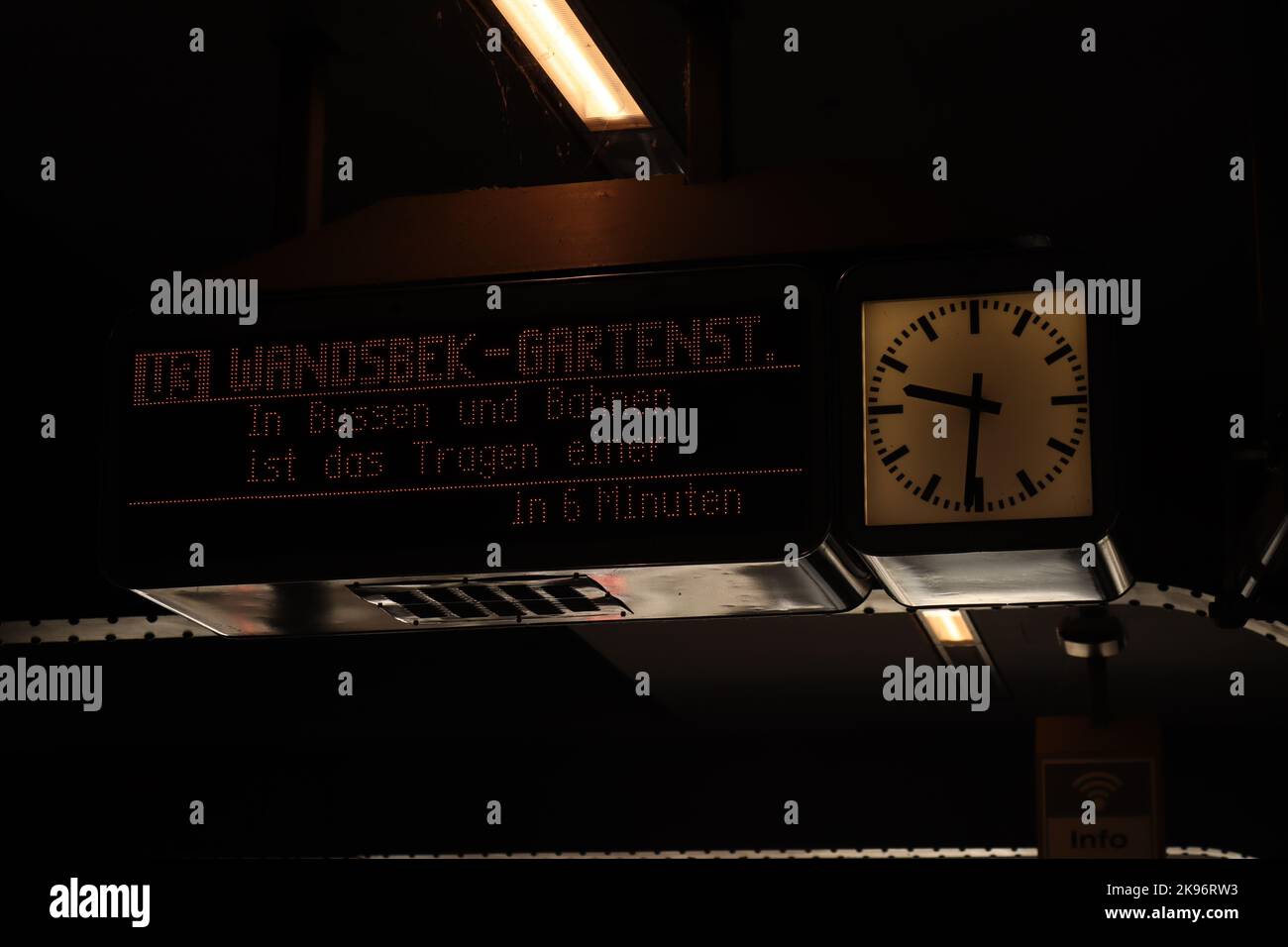 A clock and the digital timetable in a station Stock Photo - Alamy