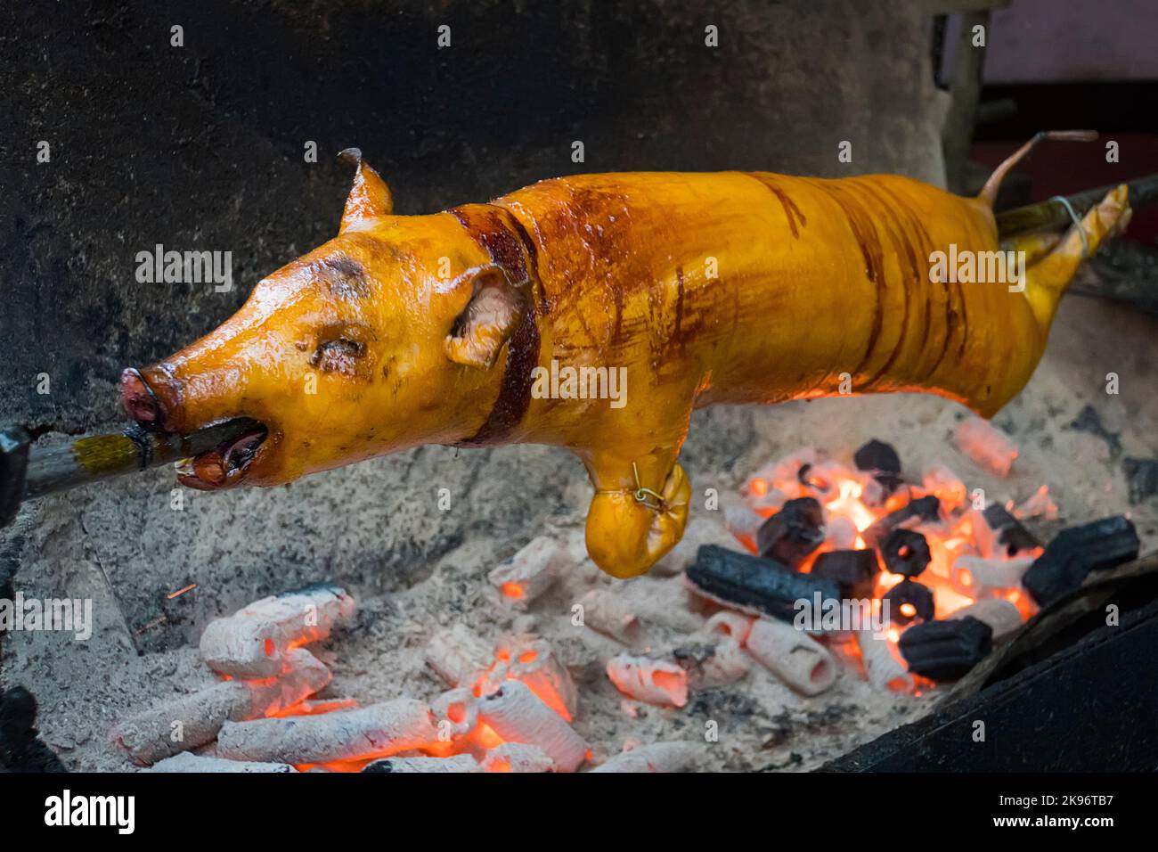 Outdoor roasting Pig on the grill in the open fire. browned delicious ...