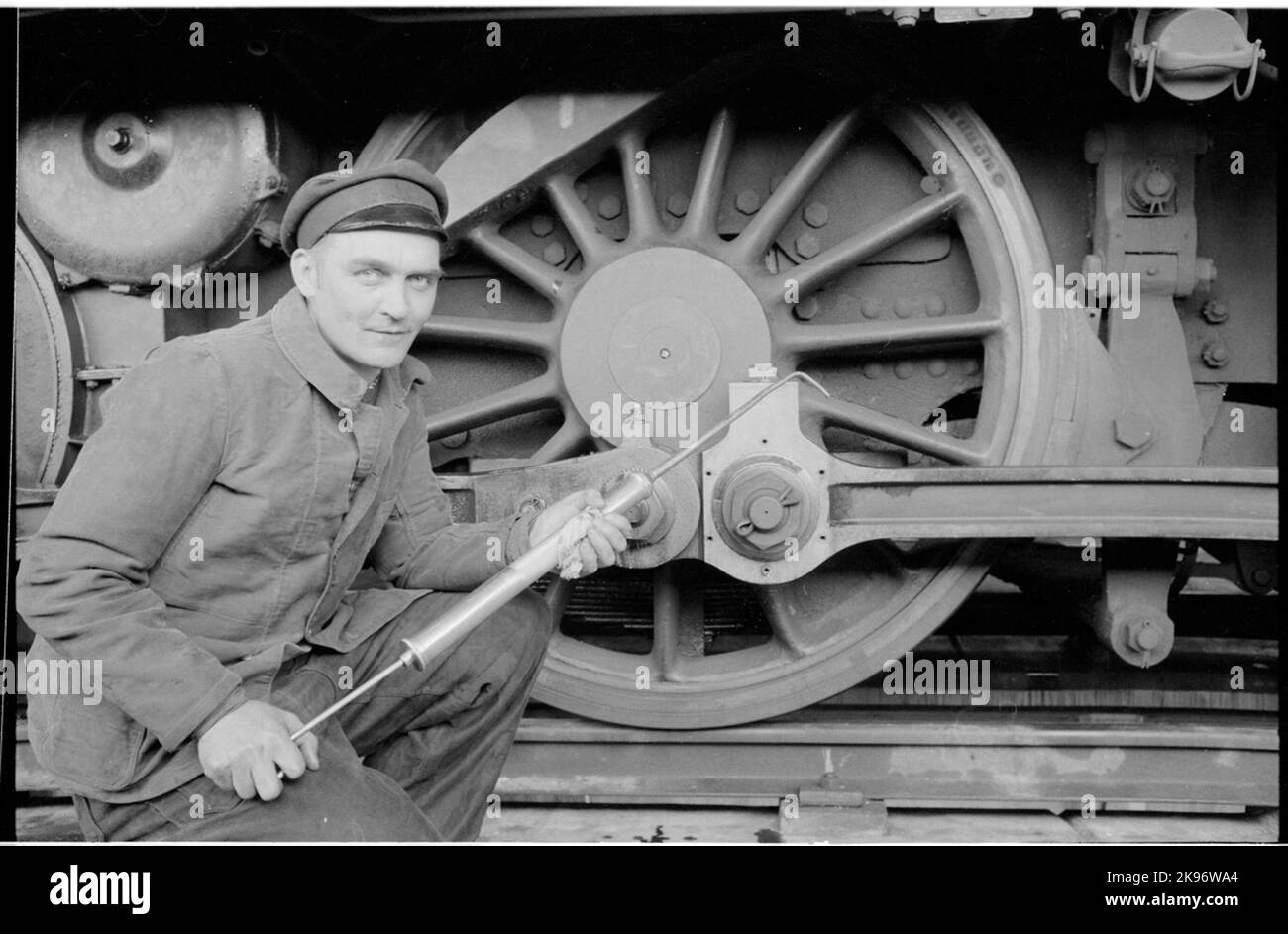 Workshop worker with lubrication Stock Photo - Alamy