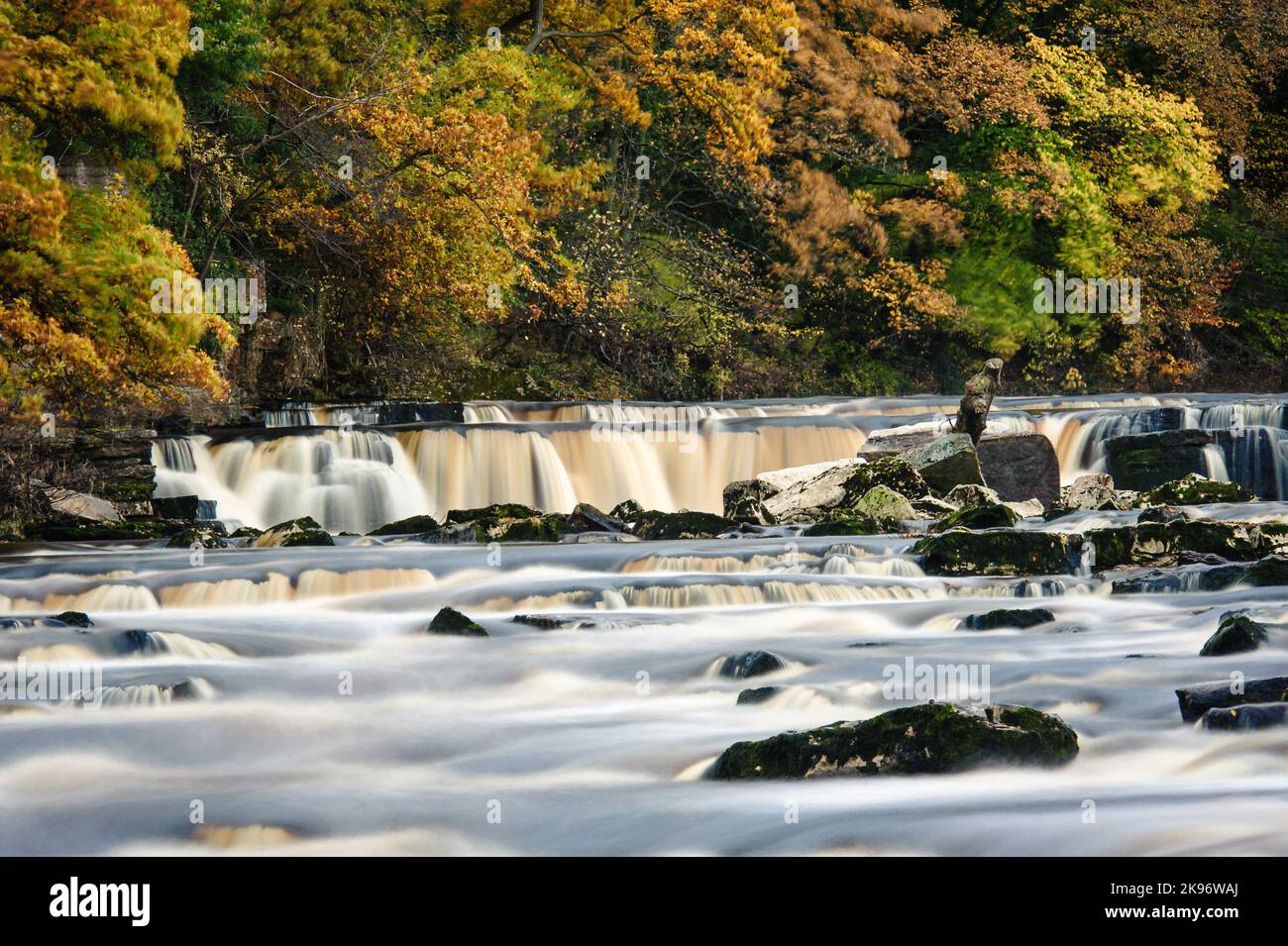 Autumn colours above long exposure of the waterfall in Richmond, North ...