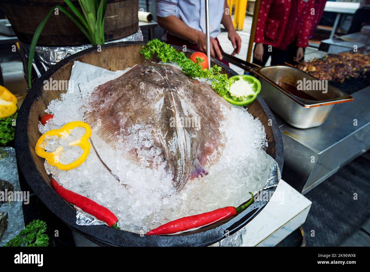 a large fresh Stingray in an ice barrel lies in the restaurant ...