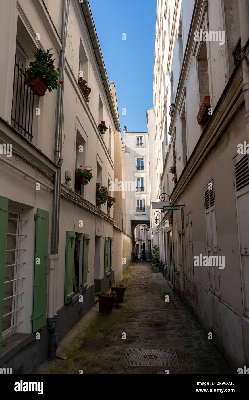 A vertical shot of a narrow street surrounded by beautiful old ...