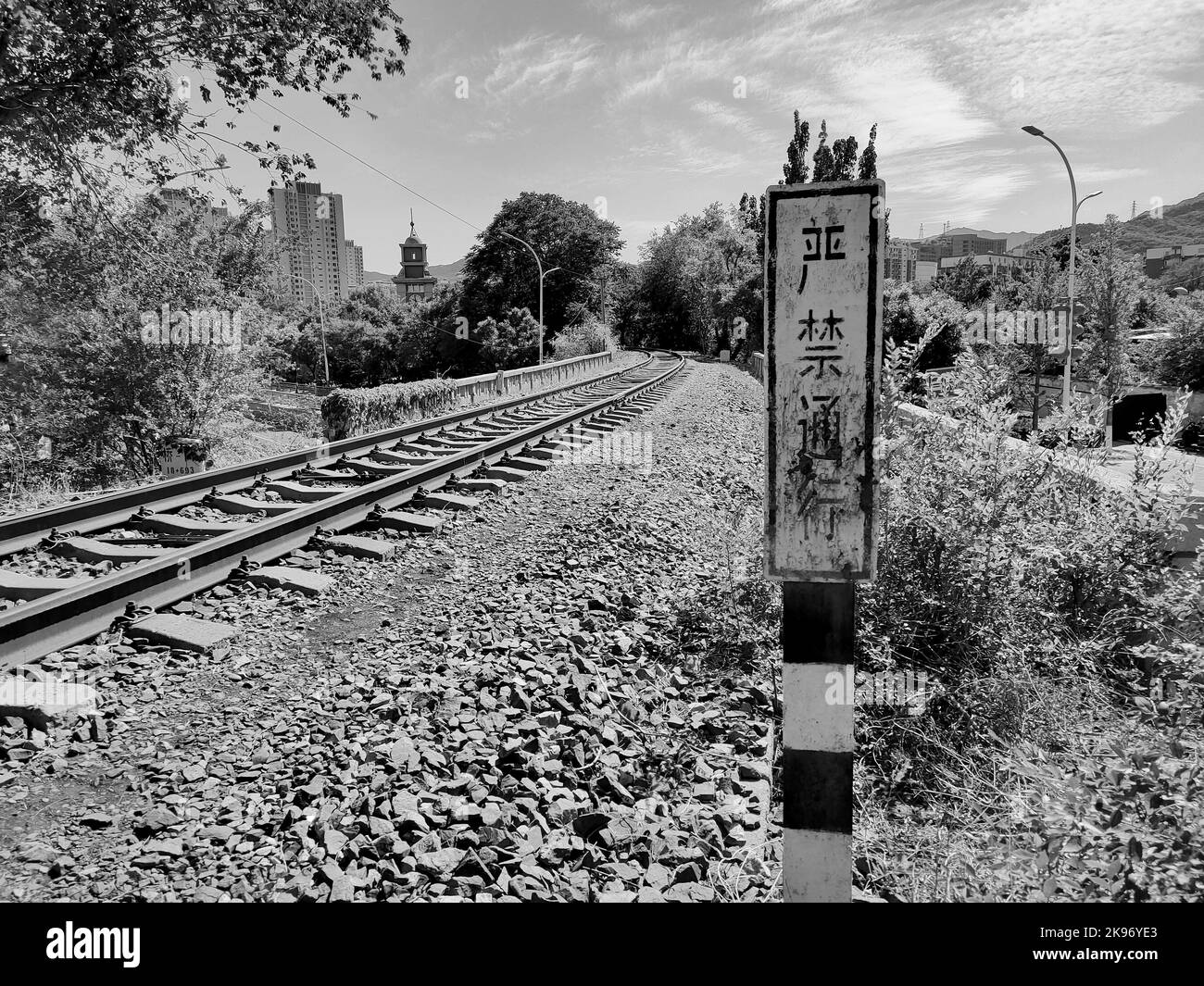 An abandoned railway and a sign, grayscale Stock Photo - Alamy
