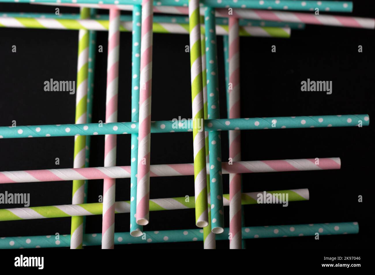 photo Multicolored cocktail straws on a black background Stock Photo ...