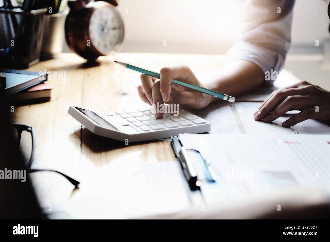 Business woman using calculator to review balance sheet annual using ...