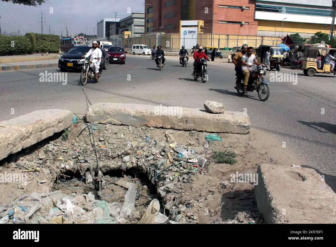 Hyderabad, Pakistan, October 26, 2022, Commuters pass through an open ...