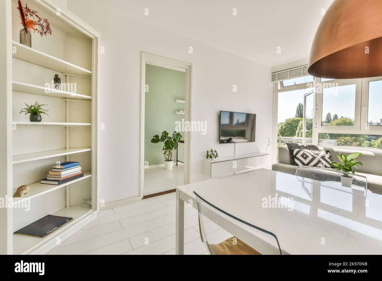 Table with chairs and flowers located near lounge area and kitchen in ...