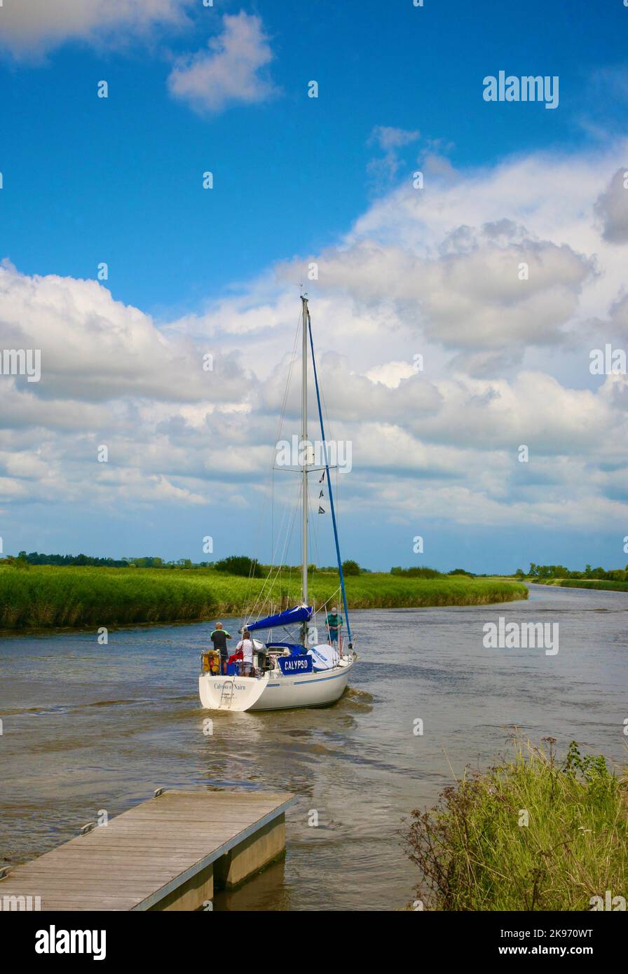 A pleasure boat leaving the Port of Caretan, Normandy, France, Europe ...