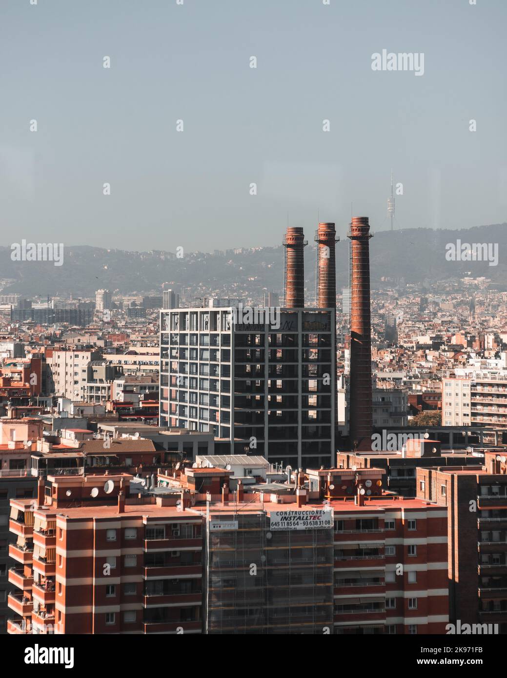 A view of three chimneys and buildings in the center of Barcelona Stock ...