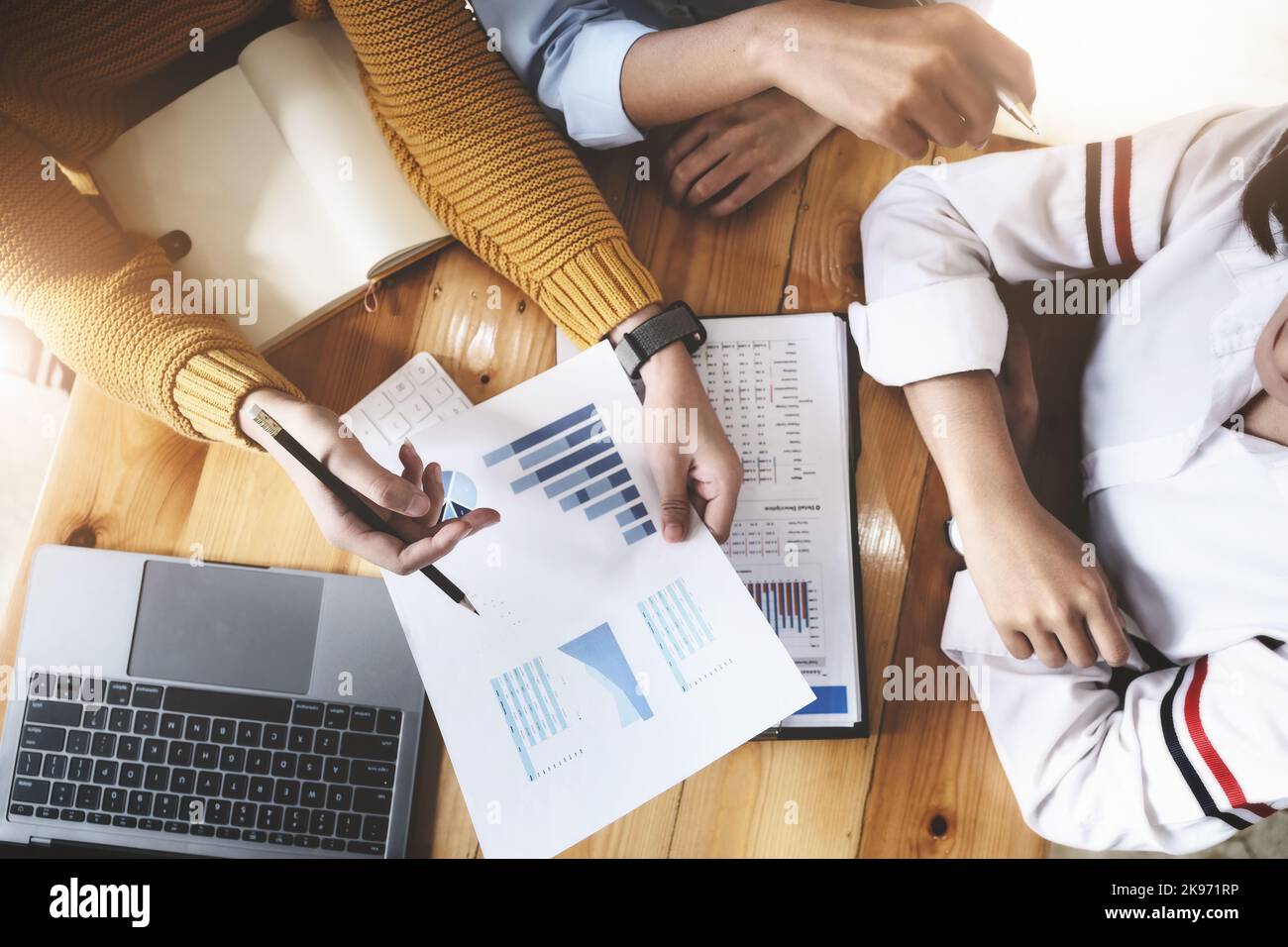 The auditor hand holding pen and budget graph document to examine the ...