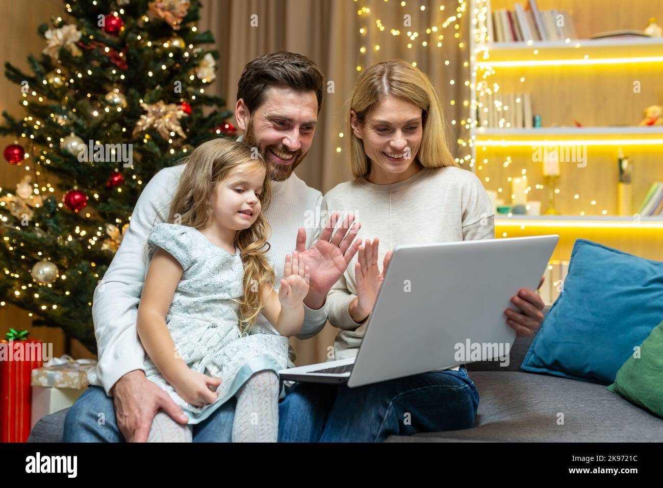 family on christmas talking with friends and online greetings and ...