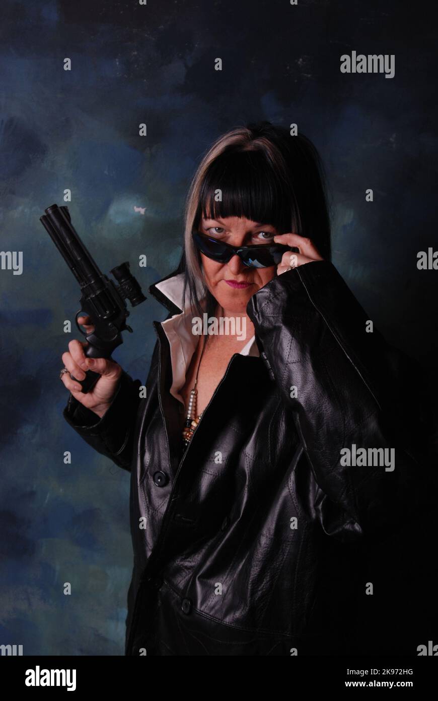 A vertical shot of an elderly secret agent spy woman in a leather ...