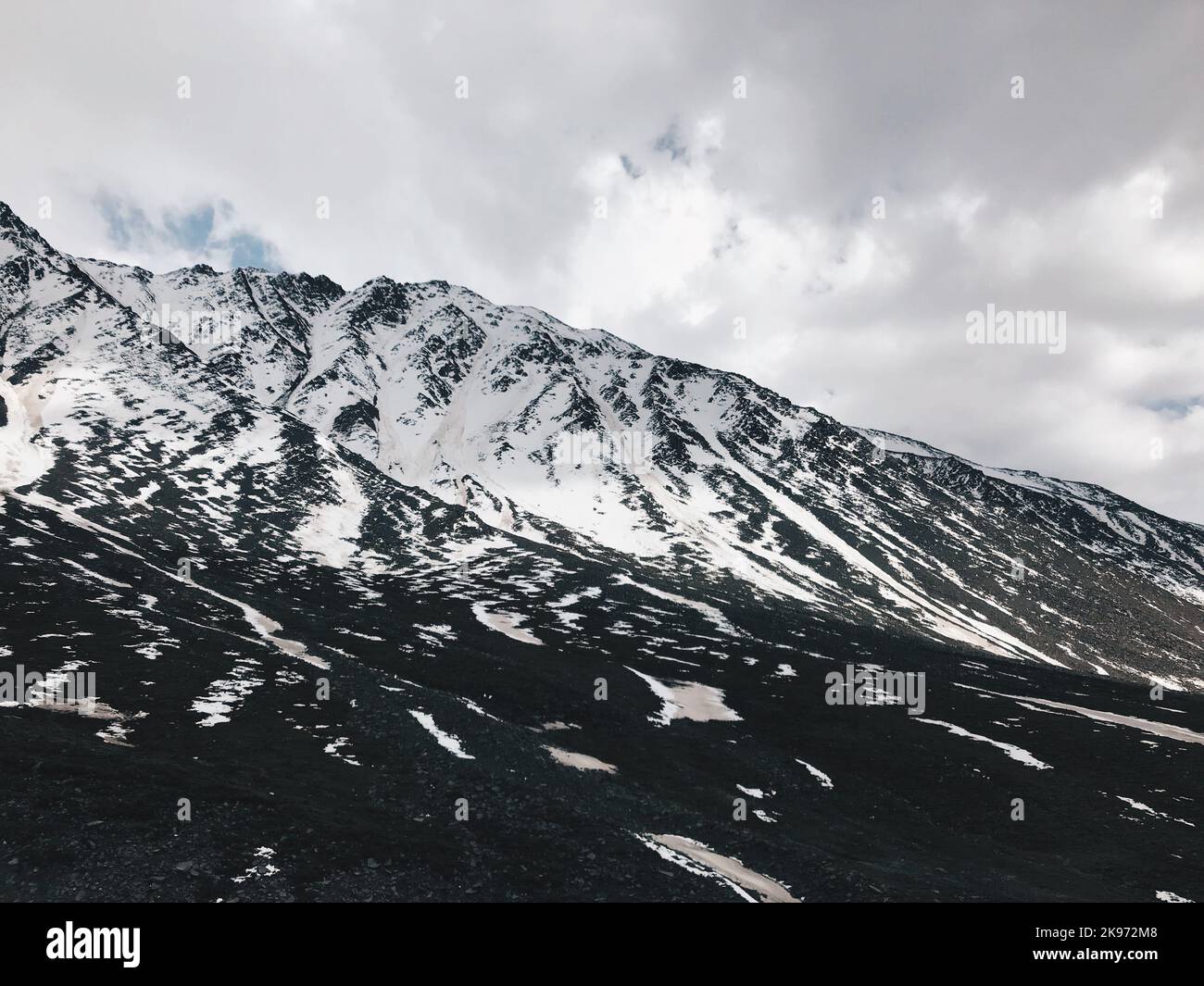A beautiful shot of a landscape covered in snow under the big white ...