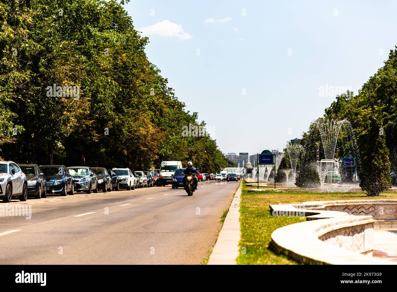 Biker on a motorcycle in traffic at rush hour in downtown area of the ...