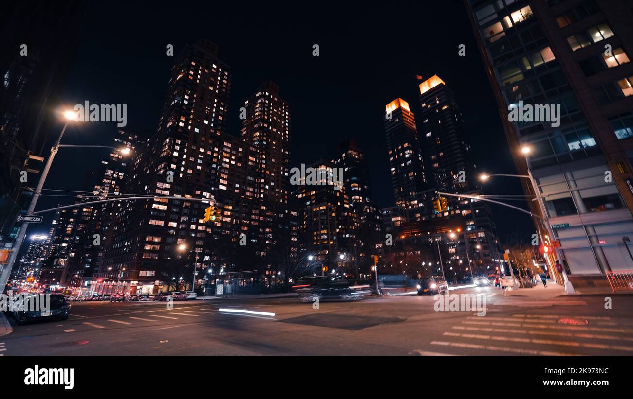 A street view of high modern buildings with lights at night Stock Photo ...