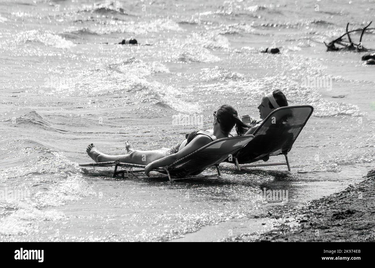 Two women sunbathers on lawnchairs in South Lindstrom Lake at Beach ...