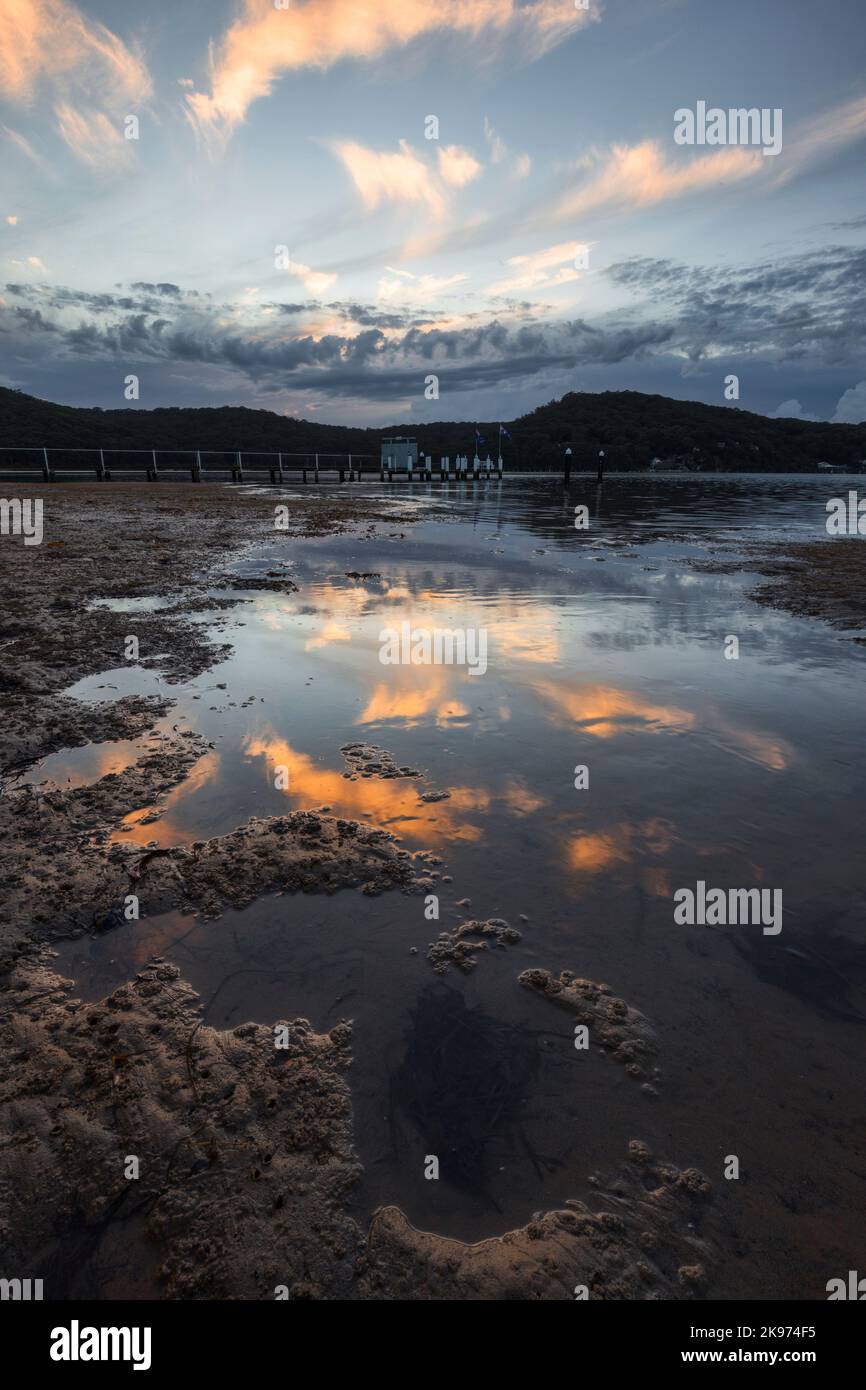A vertical shot sunrise reflection in water Stock Photo - Alamy