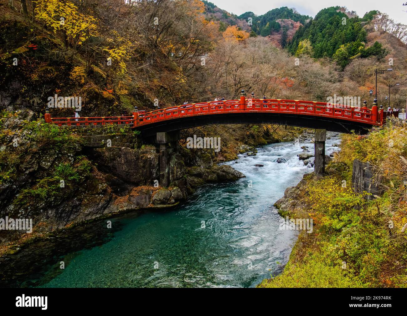 A red Shinkyo Bridge over the river in Nikko, Japan Stock Photo - Alamy