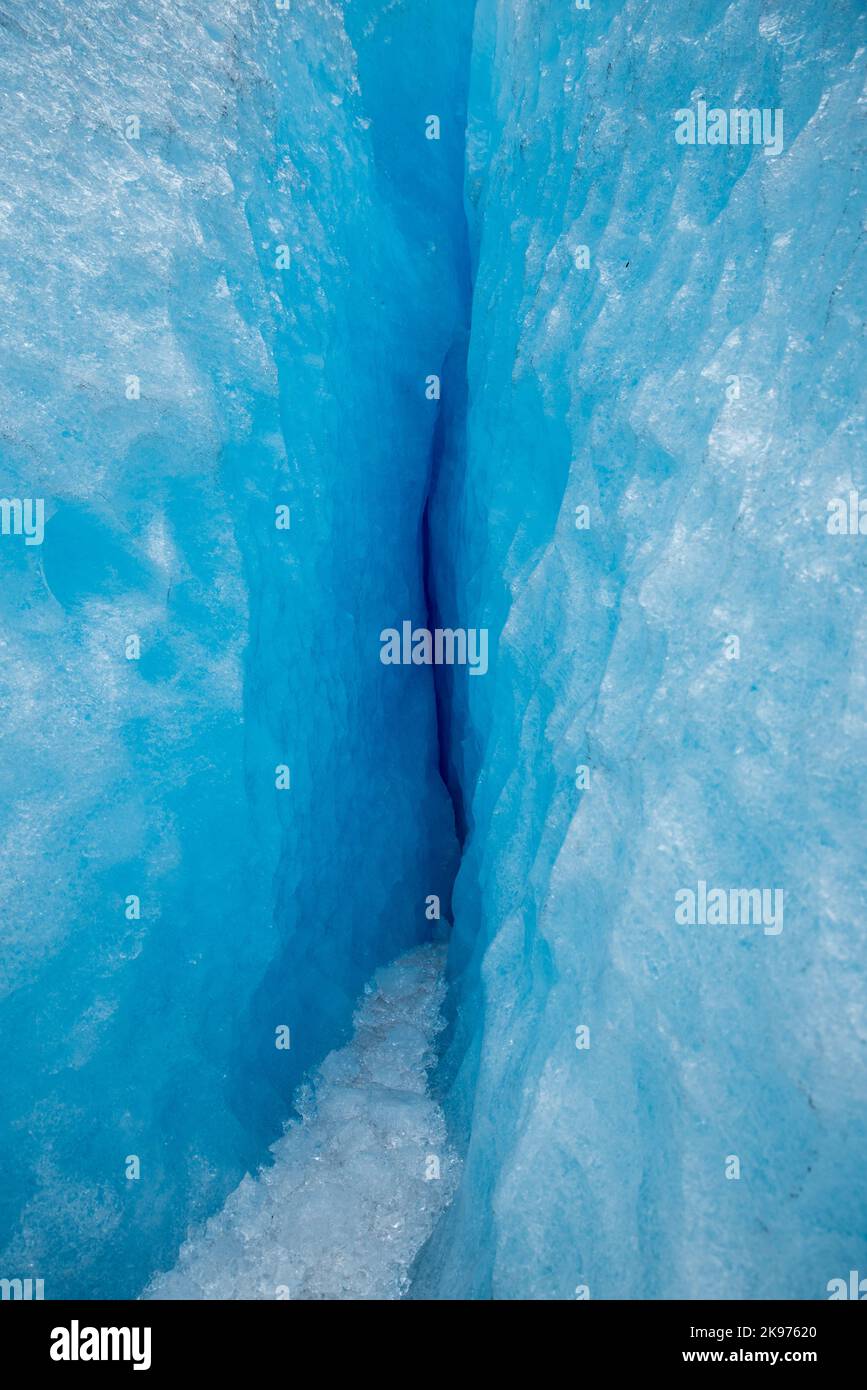 A vertical shot of multi-layered crevasse of blue ice Stock Photo - Alamy