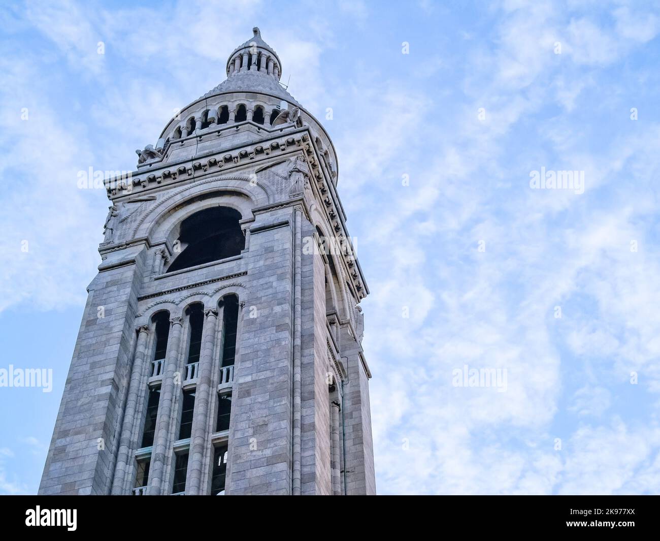 Tall tower against blue cloudy sky in Paris France Stock Photo - Alamy