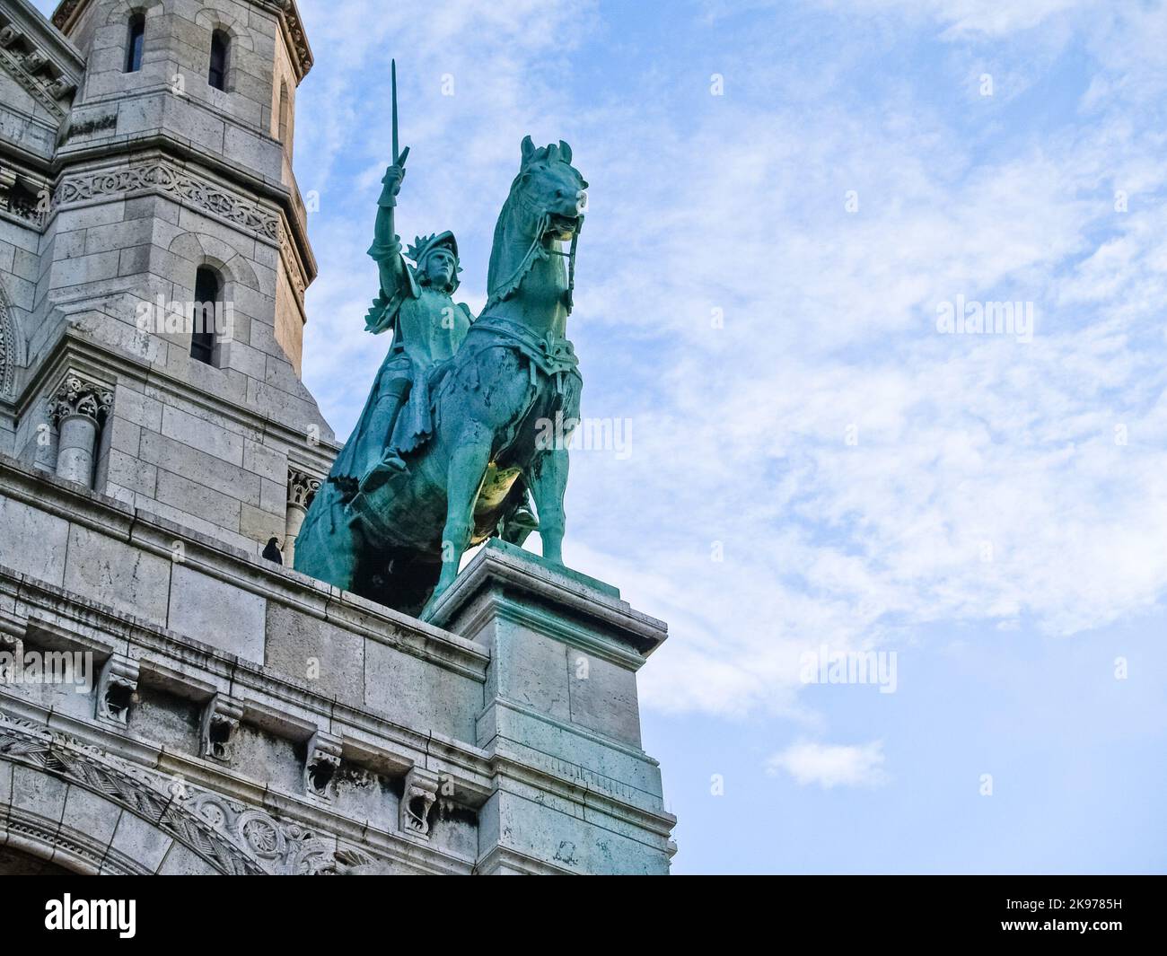 Green patina on bronze statue of soldier on horse holding sword aloft ...
