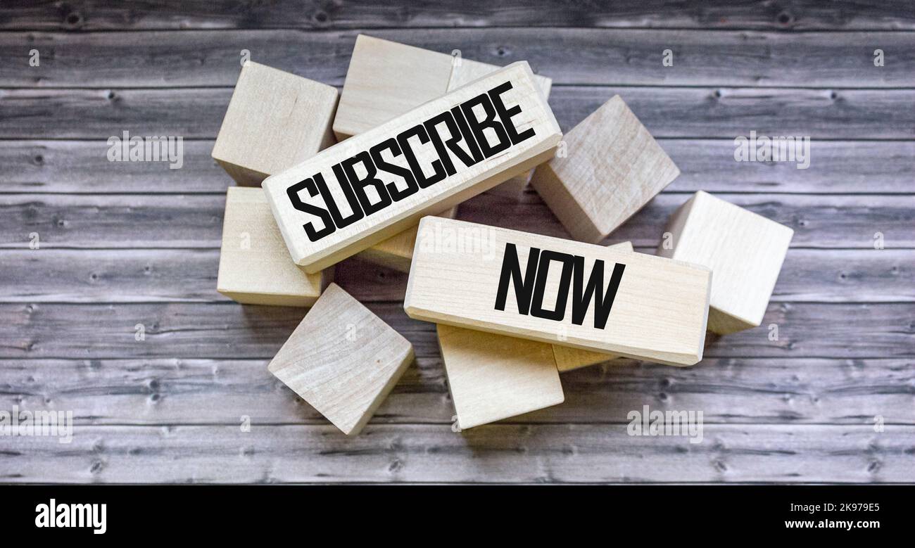 SUBSCRIBE NOW text on wooden blocks and wooden background. Concept ...