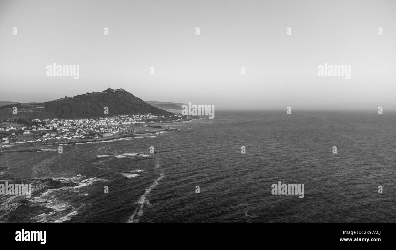 A monochrome view of the sea and hills on sunset Stock Photo - Alamy